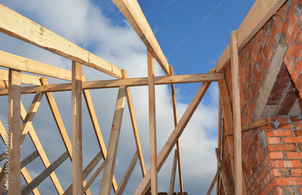 Roofing construction on the stage of roof framing. A close-up of wooden ...