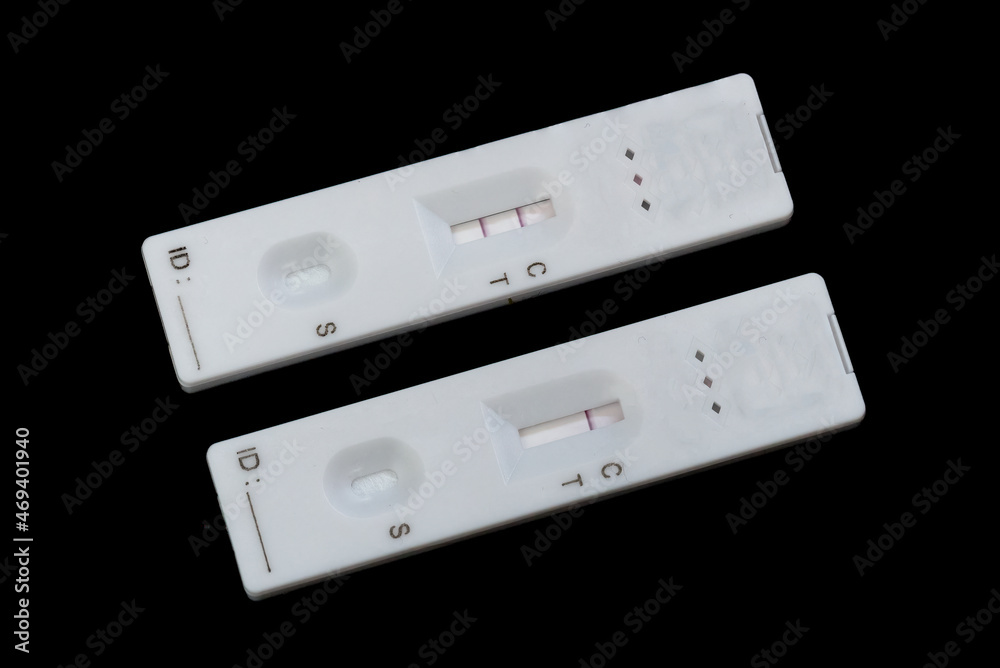 Two Covid-19 Rapid Lateral Flow Tests, one showing a negative result ...