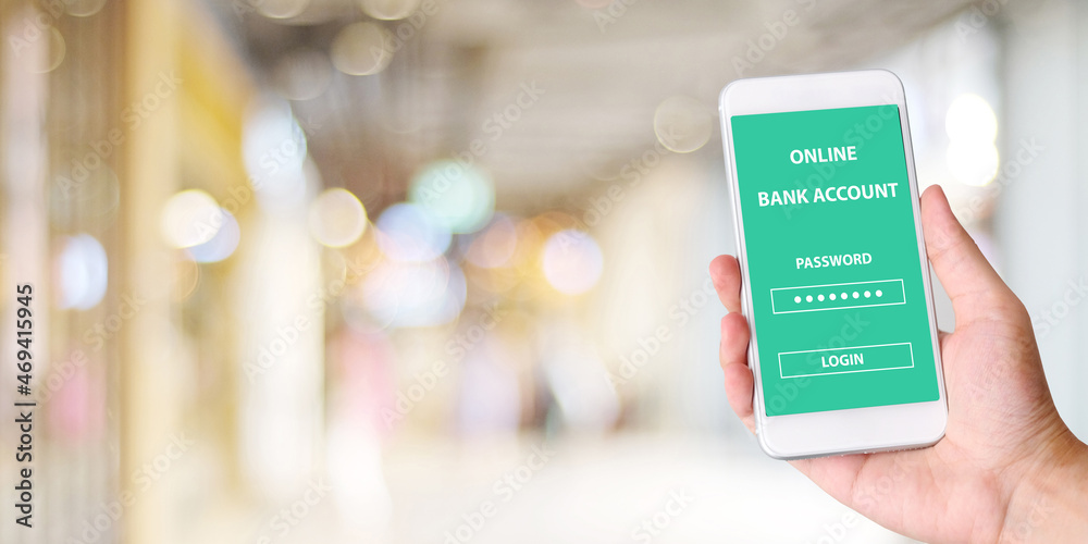 Hand using smartphone with online bank account password login on screen ...