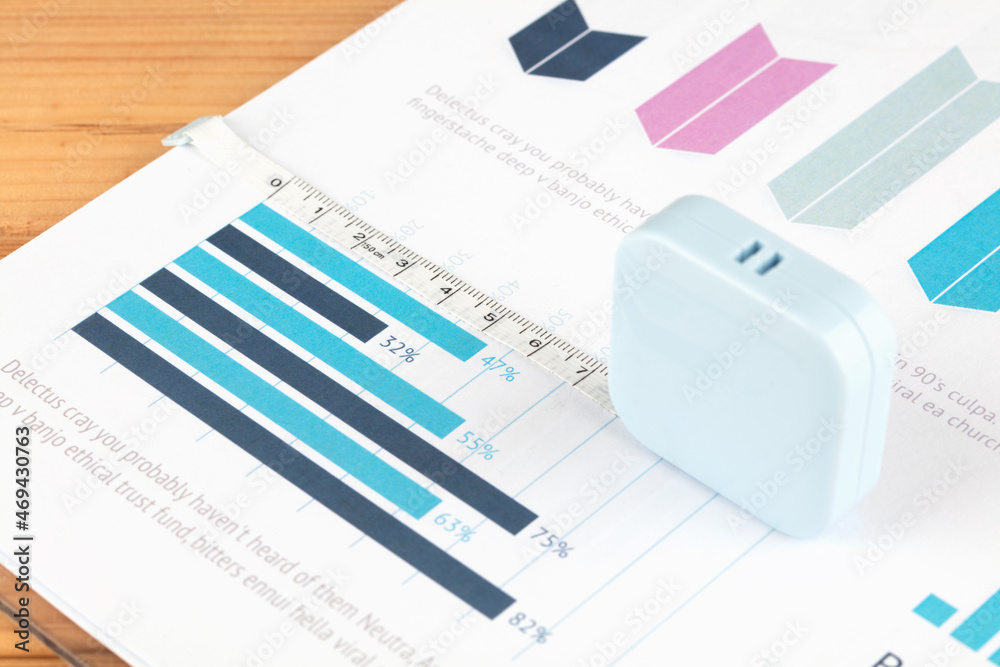 Measuring the growth of a bar graph with a soft ruler on a financial ...