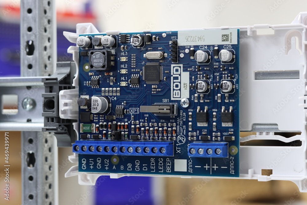 The fire alarm controller is mounted on a din rail installed in the ...