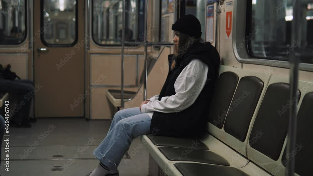 Lonely desperate depressed female sitting in a subway metro. Sad young ...