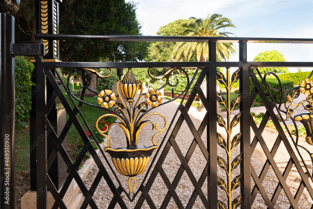 Decorative iron gate on the territory of the Bahai Garden, located on ...