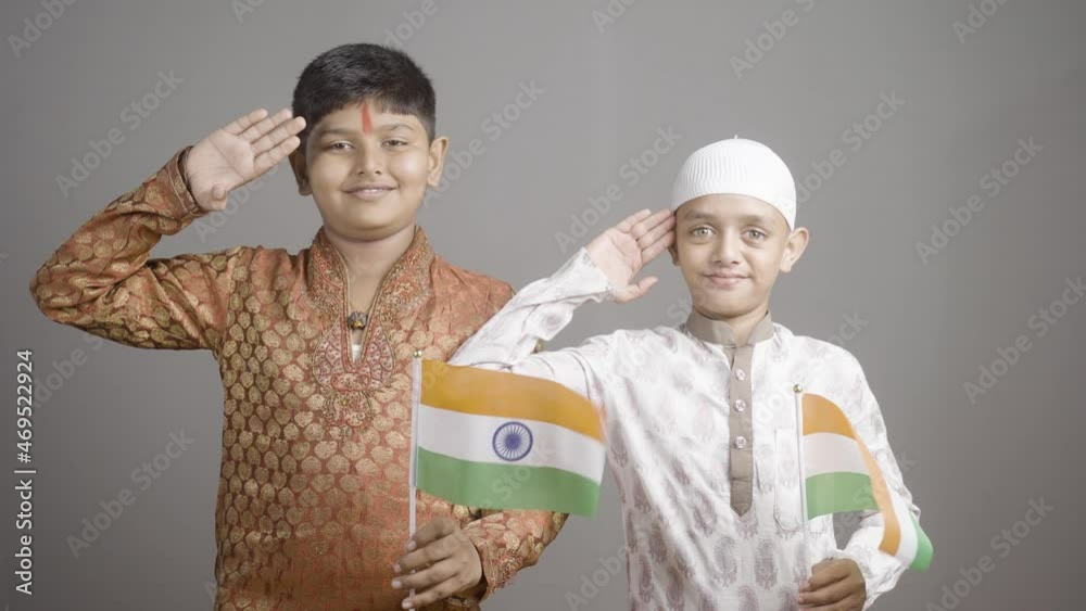 HIndu Muslim Children saluting by holding Indian flag on gray ...
