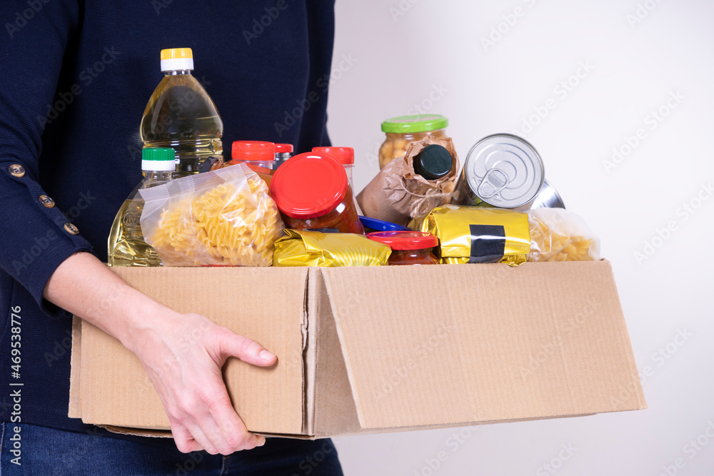 Woman volunteer hands holding food donations box with food grocery ...