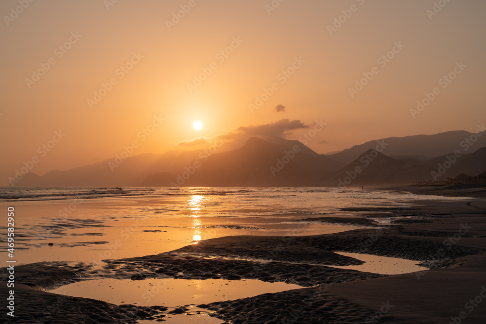Golden Sunset over Omani Coast" Description: The sun sets over the ...