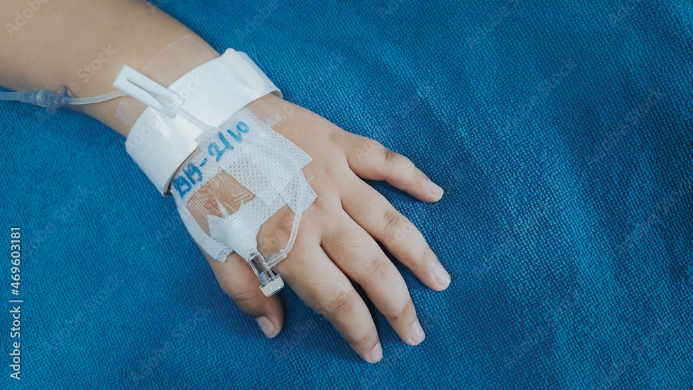 Patients little boy with infusion pump infuses fluids on hands medical ...