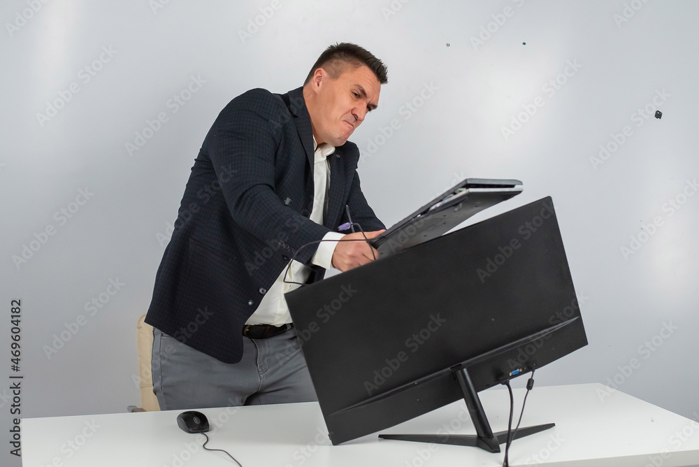 Caucasian man in a suit gets angry and smashes the keyboard on the ...