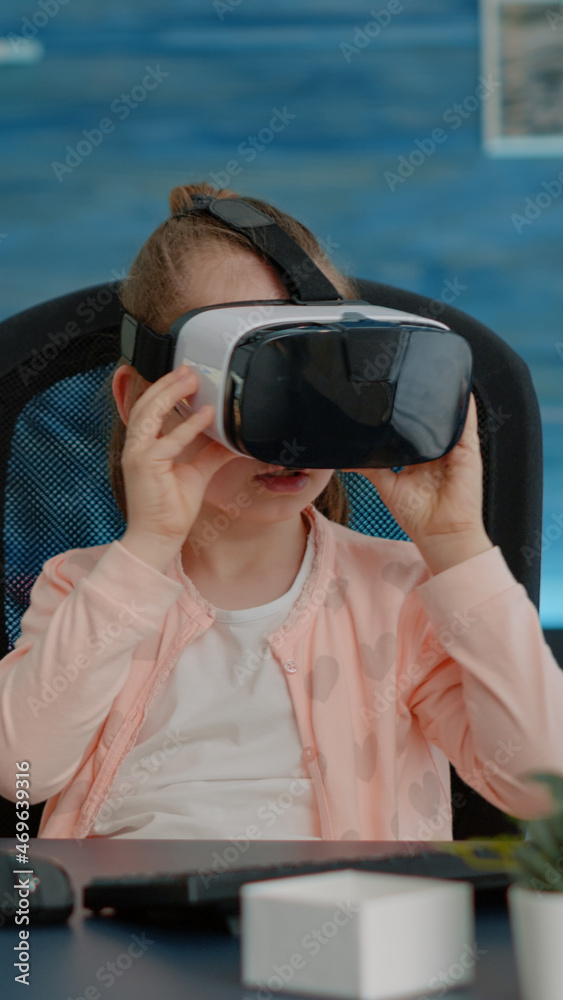 Young girl wearing vr glasses for virtual reality exercise at school ...
