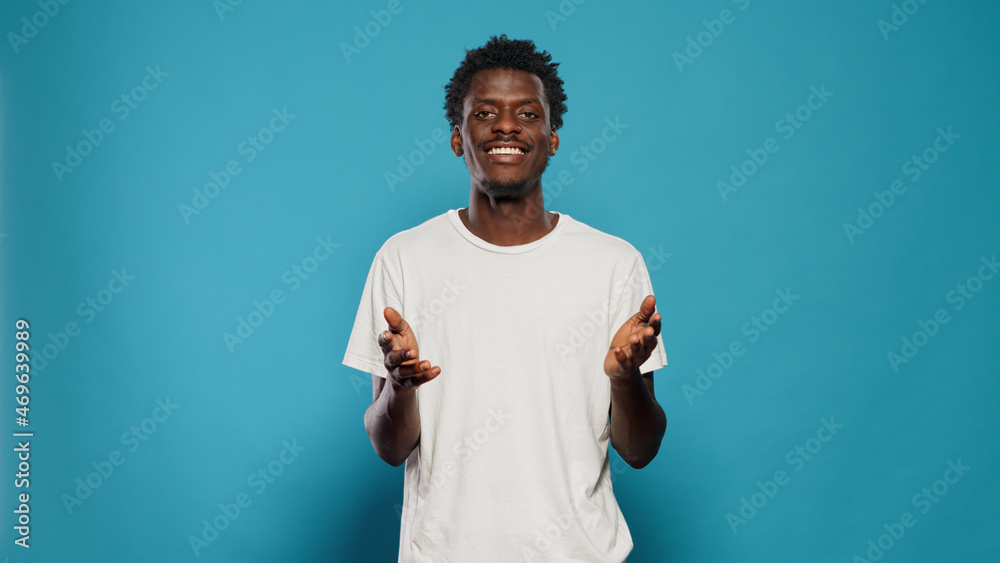 Young adult talking and doing hand gestures on camera in studio ...