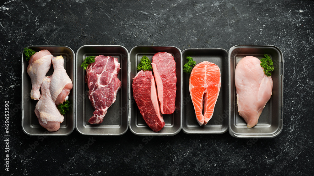 Set of fresh raw meat and fish in plastic boxes: veal, salmon steak ...
