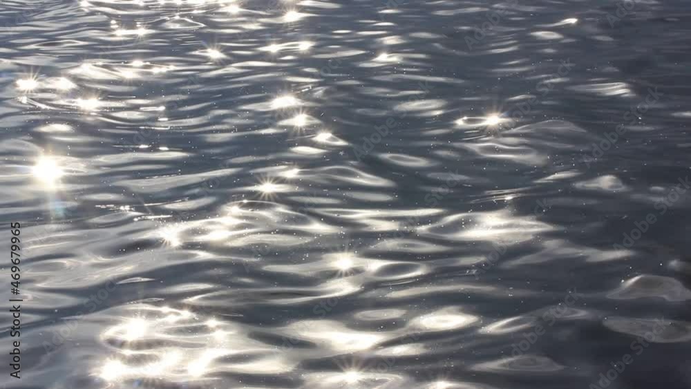 The sun's rays reflecting on a surface of a water. Sunbeams shimmering ...
