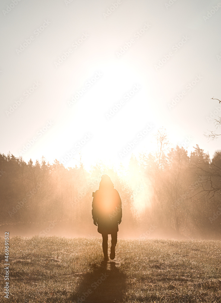 Girl standing in thick fog with a colorful morning sunlight. Human ...