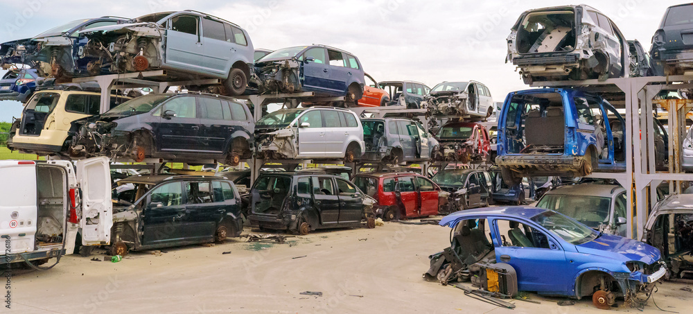 Old rusty corroded and crushed cars in car scrapyard. Car recycling ...
