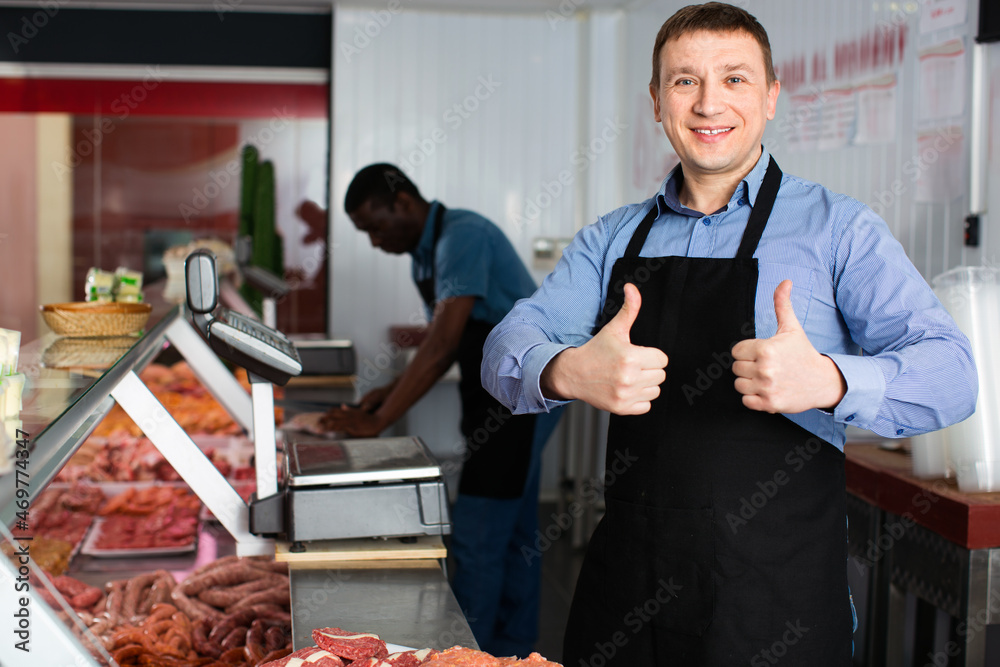 Proud cheerful positive smiling male owner of butcher shop standing ...