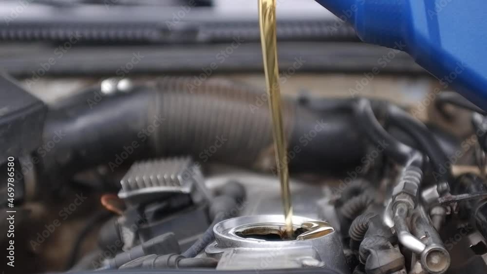 Refueling with fresh engine oil.Engine oil pours from the canister into ...