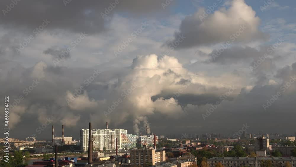 Clouds from chimneys. A lot of pipes in industrial, residential area ...