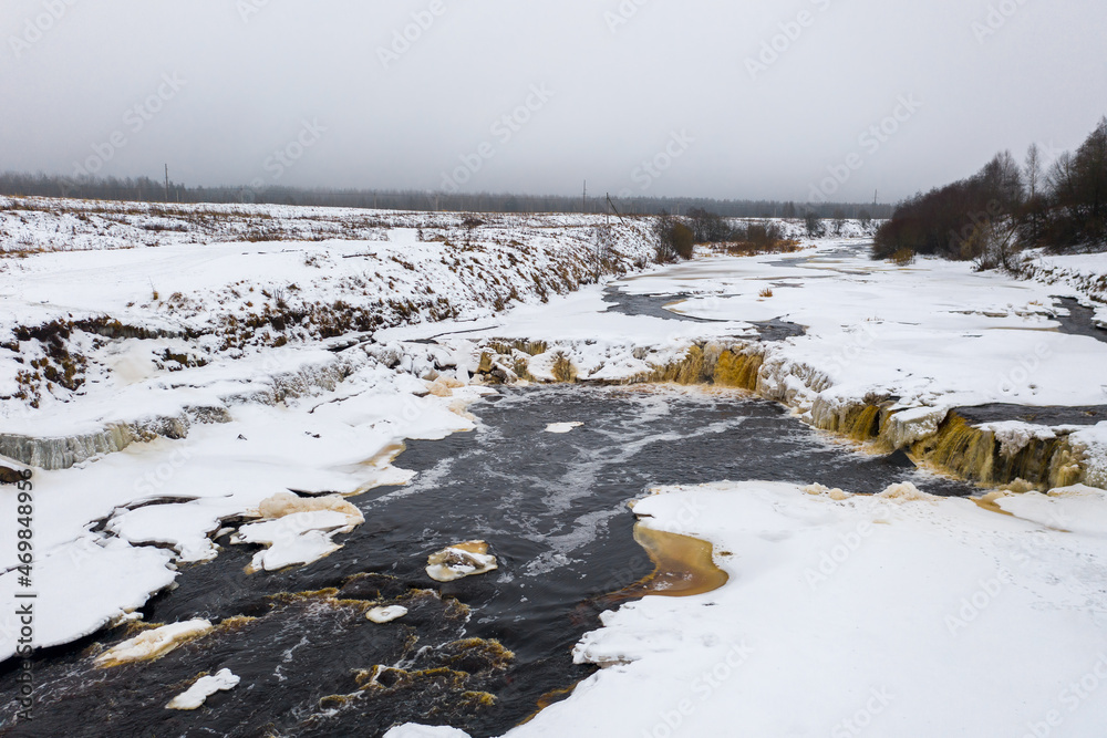 Foto de Winter aerial view of the river valley and waterfall. Freezing ...