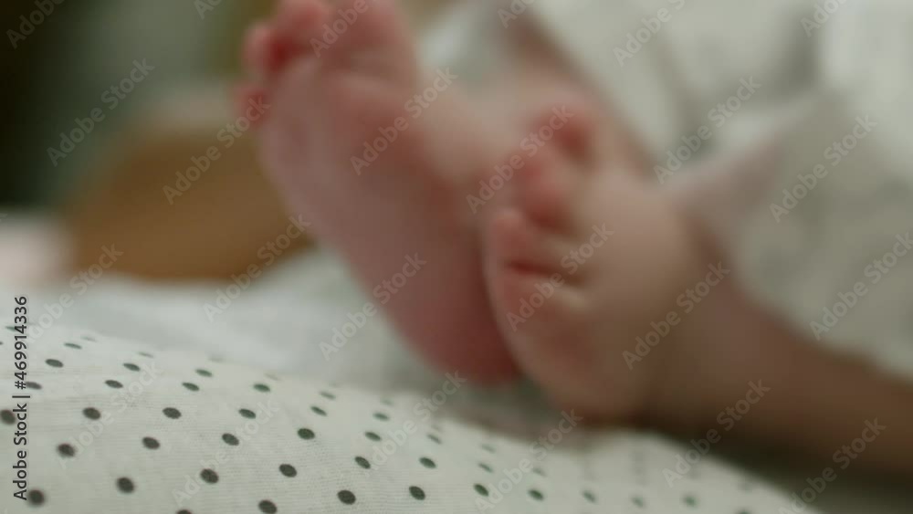 Close up newborn baby girl or boy lying on mother's belly and moving ...