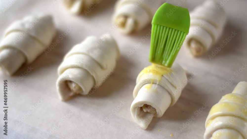 Raw croissants made of puff pastry with almond filling. Covering raw ...