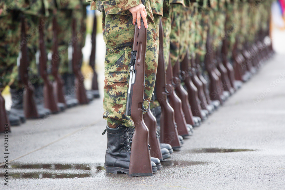 Soldiers in boots and a rifle.Soldiers stand in row. Gun in hand. Army ...
