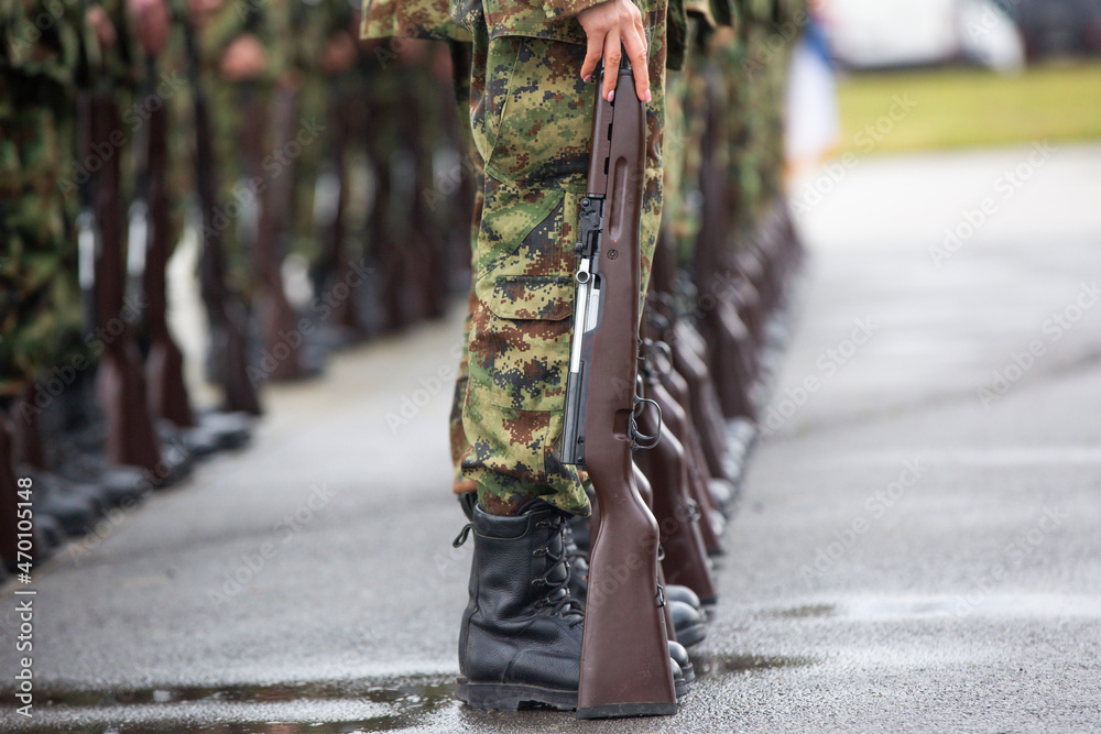 Soldiers in boots and a rifle.Soldiers stand in row. Gun in hand. Army ...