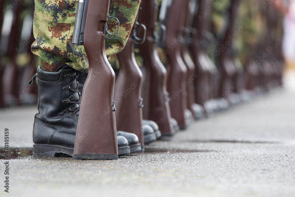 Soldiers in boots and a rifle.Soldiers stand in row. Gun in hand. Army ...