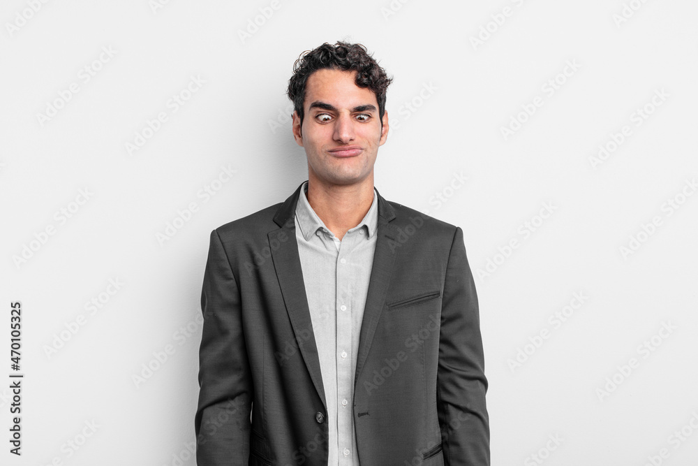 young businessman looking goofy and funny with a silly cross-eyed ...