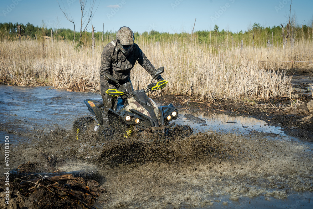 ATV and UTV offroad vehicle racing in hard track with mud splash ...