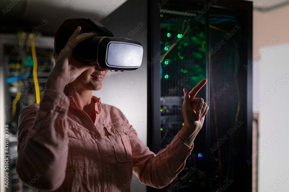 Caucasian woman wearing vr headset touching an invisible screen in ...