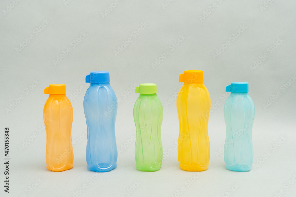 Plastic Tupperware Bottles. A stack of colour water bottles, blue ...