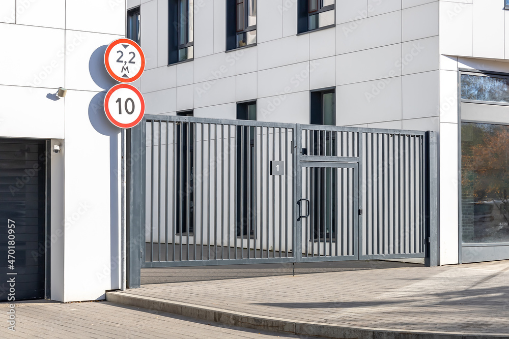 Entrance to the modern residential complex. Lattice gates with a wicket ...