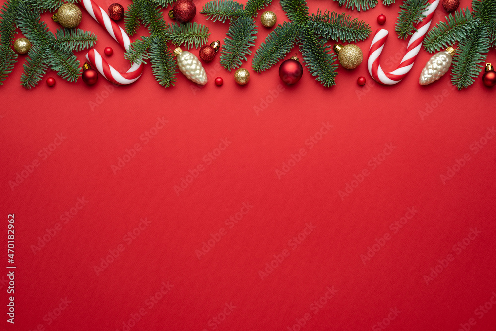 Red Christmas background with decorative border of fir branches and ...