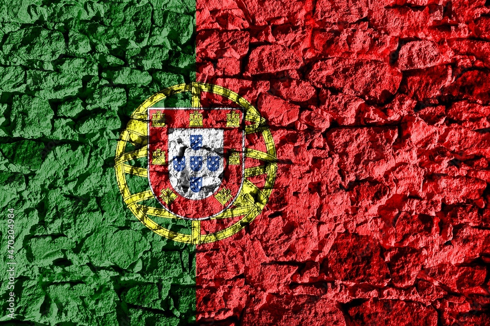Portugal flag depicted on a stone wall. The texture of the stone blends ...