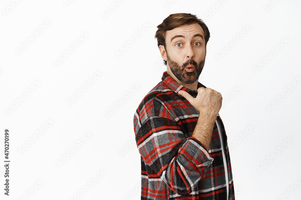 Wow check this out. Excited bearded man pulling surprised face ...
