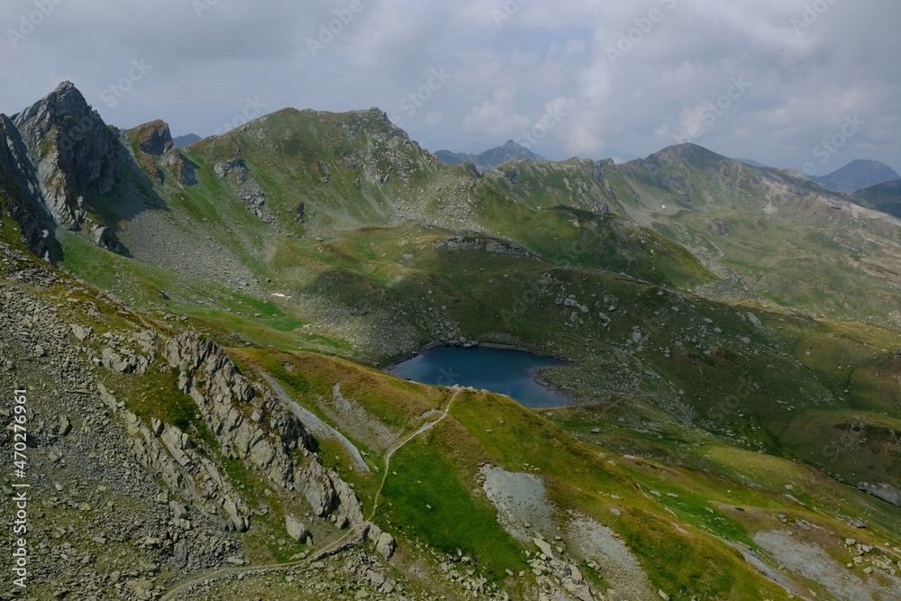 Beautiful mountain lake, view above clouds during hiking on peak ...