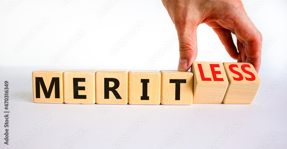 Merit or meritless symbol. Businessman turns wooden cubes and changes ...