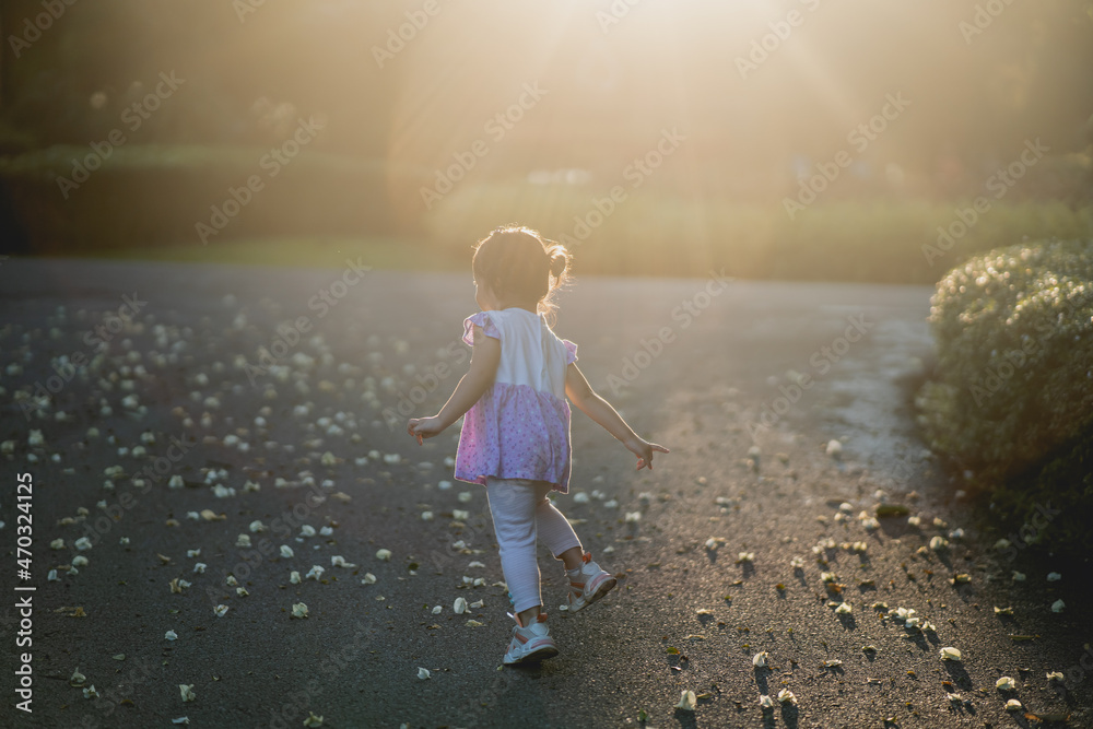 Happy baby girl smiling. little girl running at sunsetHappy baby girl ...