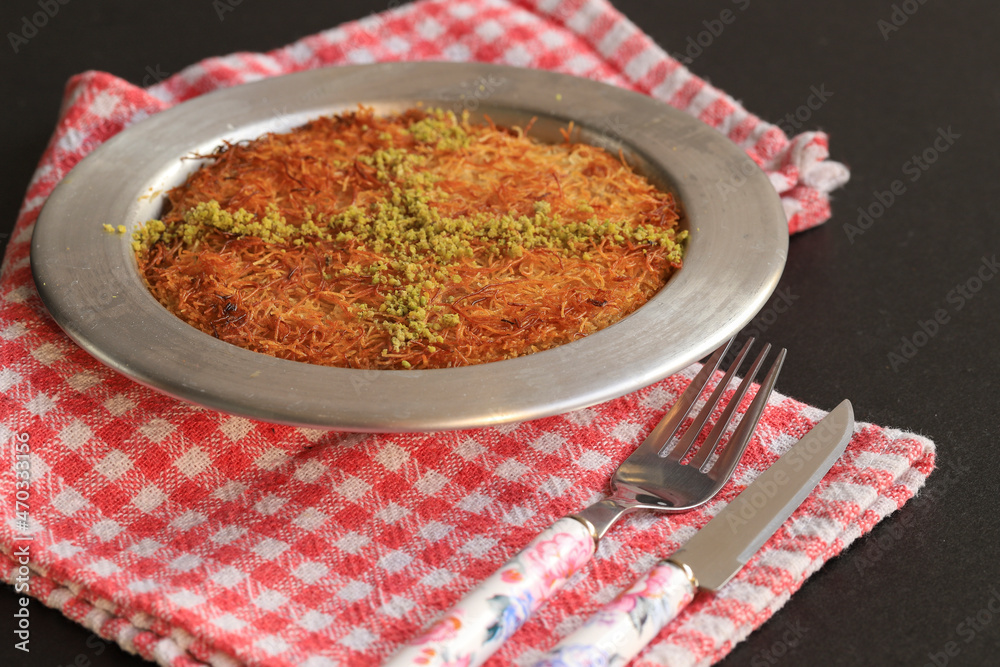 Turkish dessert kunefe, kunafa, kadayif with pistachio powder and ...