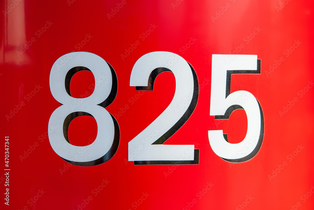 Bus number. Close-up of number 825 aboard a red old passenger bus ...