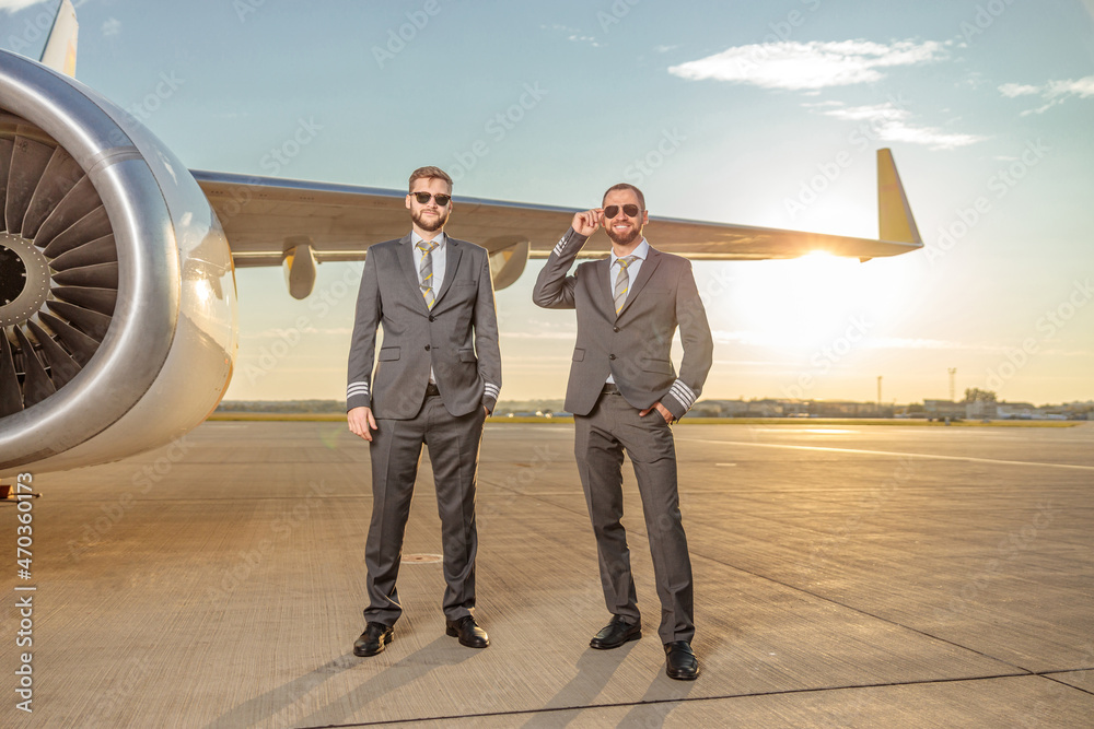 Aircraft pilots standing near airplane engine at airfield Stock Photo ...