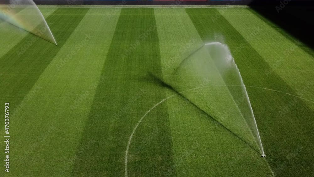 Watering football field before professional football game, lawn care ...