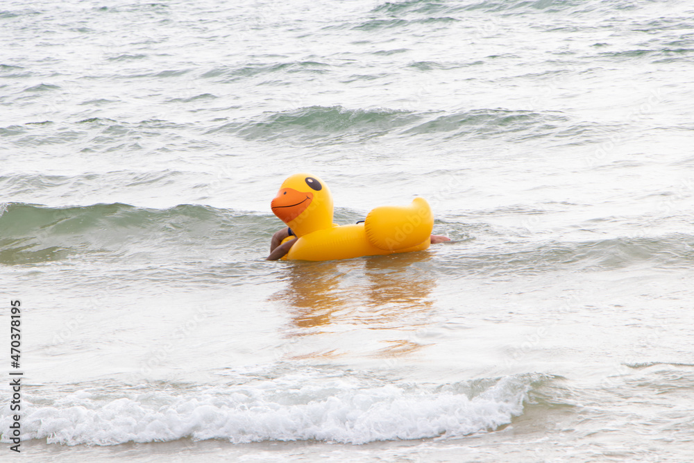 Travel in thailand trip with yellow duck swim tube on sea. Fantasy swim ...