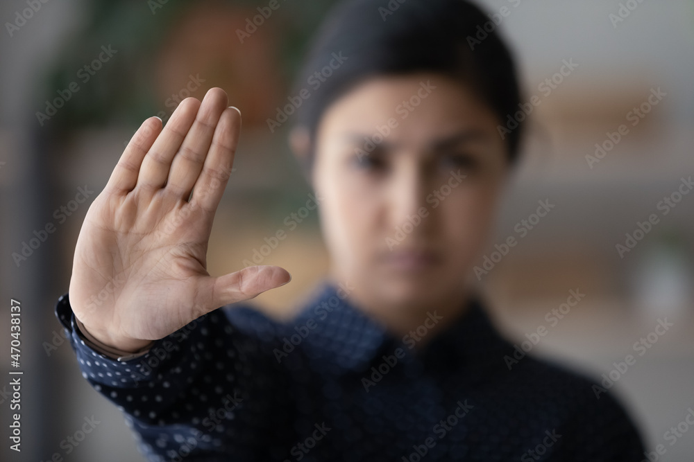 Close up focus on hand of serious young Indian woman showing stop ...