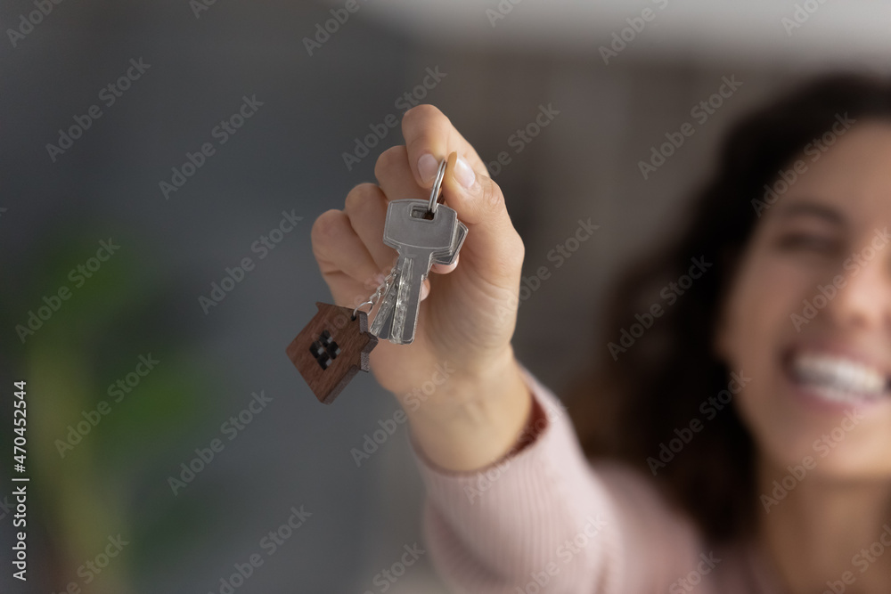 Foto de Close up cropped focus on keys in smiling laughing young woman ...