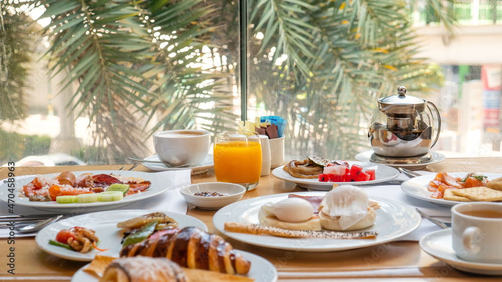 Breakfast in luxury hotel. Table full of various food from buffet in ...