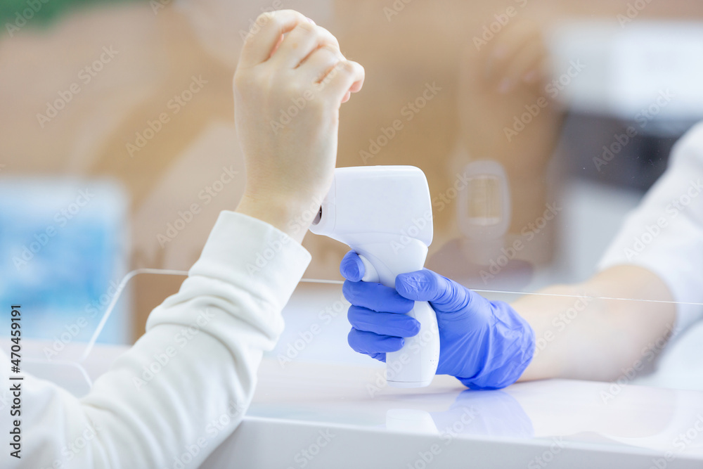 Close up of a female hand being measured body temperature with a ...