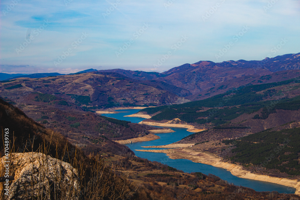 Blue wavy lake river in the middle of mountains in autumn with ultra ...