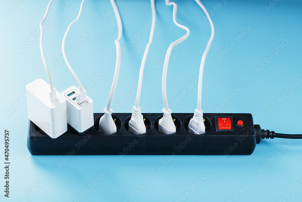 Electric mains filter with inserted white plugs of electrical ...