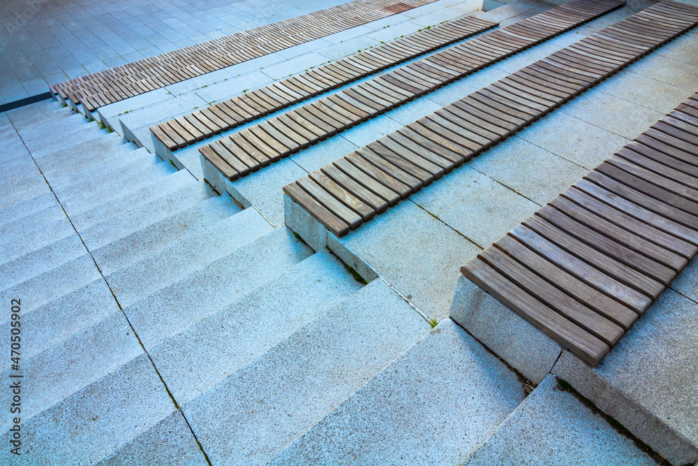 Staircase with seats. Wooden seats on the concrete stairs on outdoor of ...